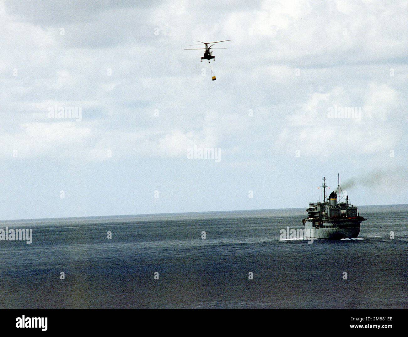A CH-46 Sea Knight helicopter approaches the combat stores ship USNS ...