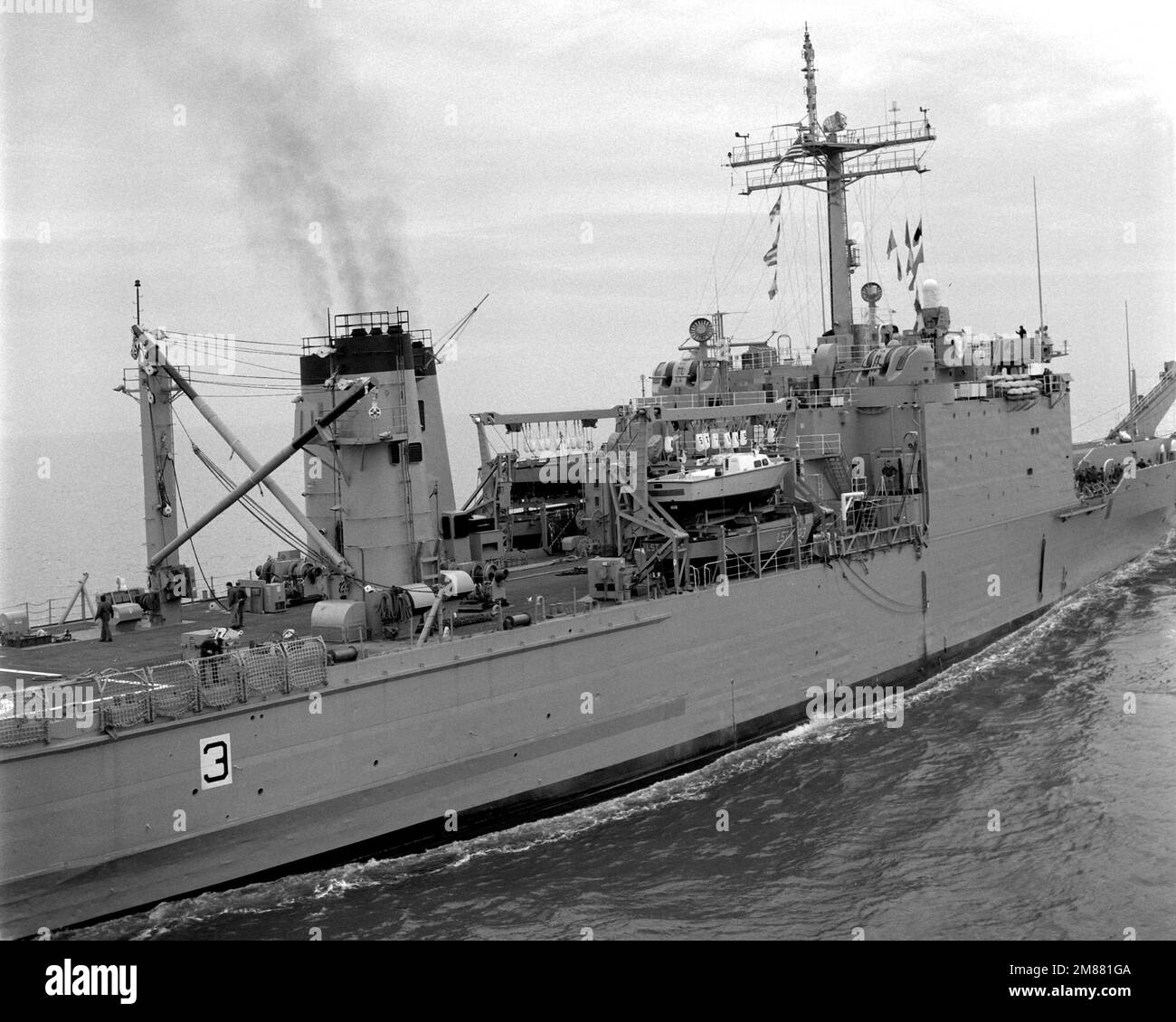 A starboard amidships view of the tank landing ship USS BARNSTABLE ...