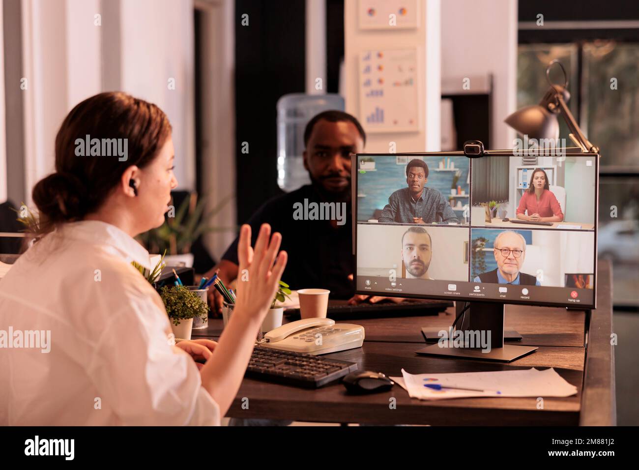 Woman discussing startup strategy with colleagues on videocall meeting ...