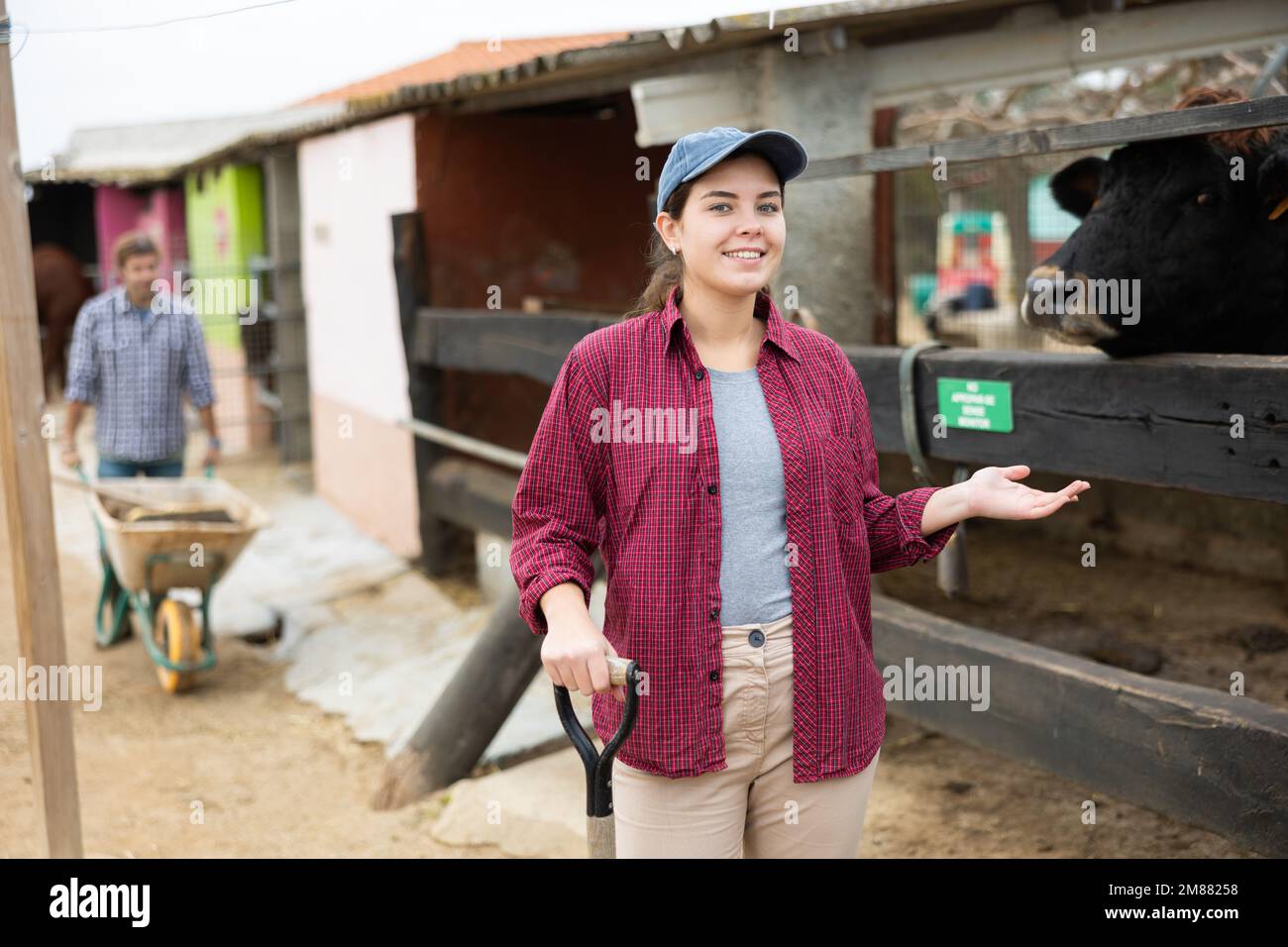 female farm worker standing with a smile and instruments Stock Photo ...