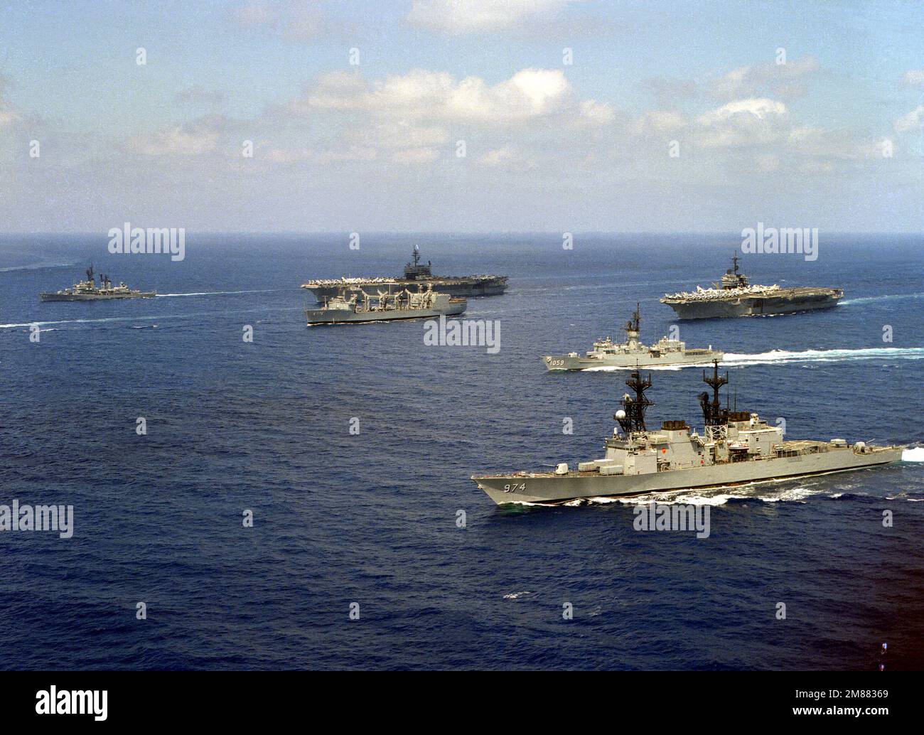 A port bow view of various U.S. Navy ships underway in formation. They ...