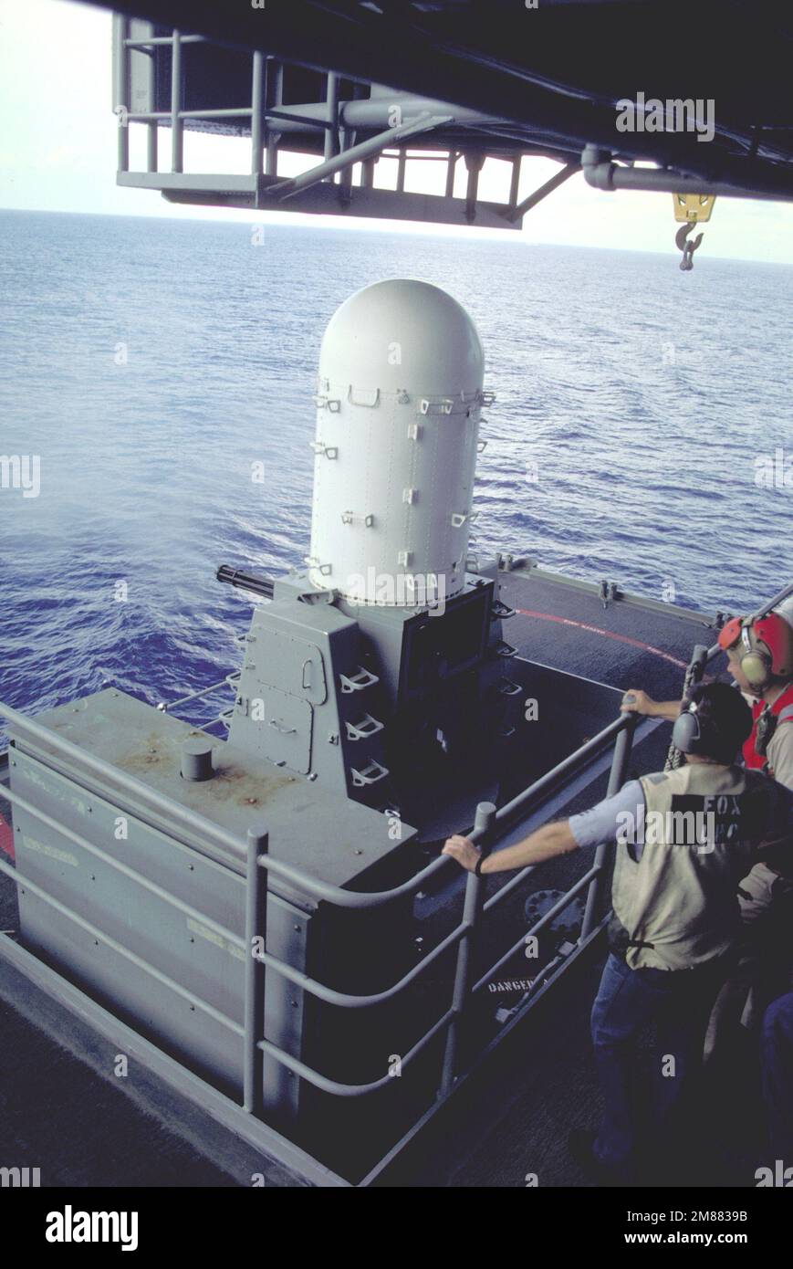 Crew members stand by as a Mark 16 20mm Phalanx close-in weapons system ...