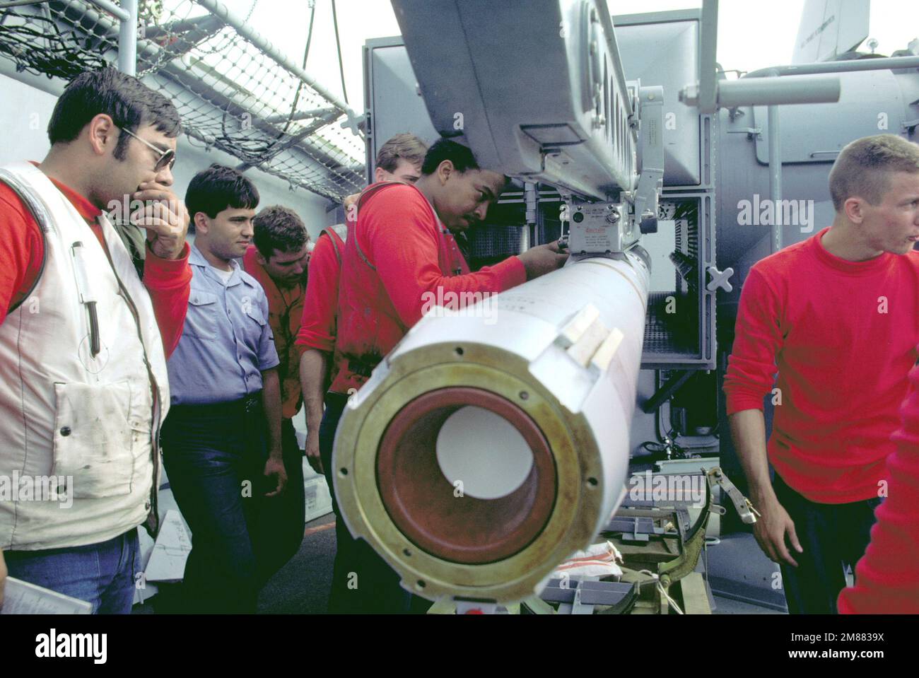 Ordnancemen load an RIM-7 Sea Sparrow missile into a Mark 29 Sea ...