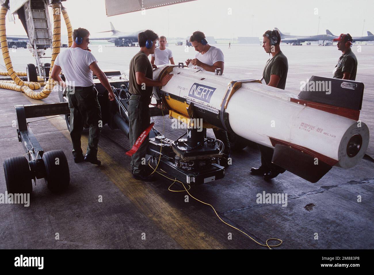 Members of the 96th Munitions Maintenance Squadron inspect an inert AGM ...