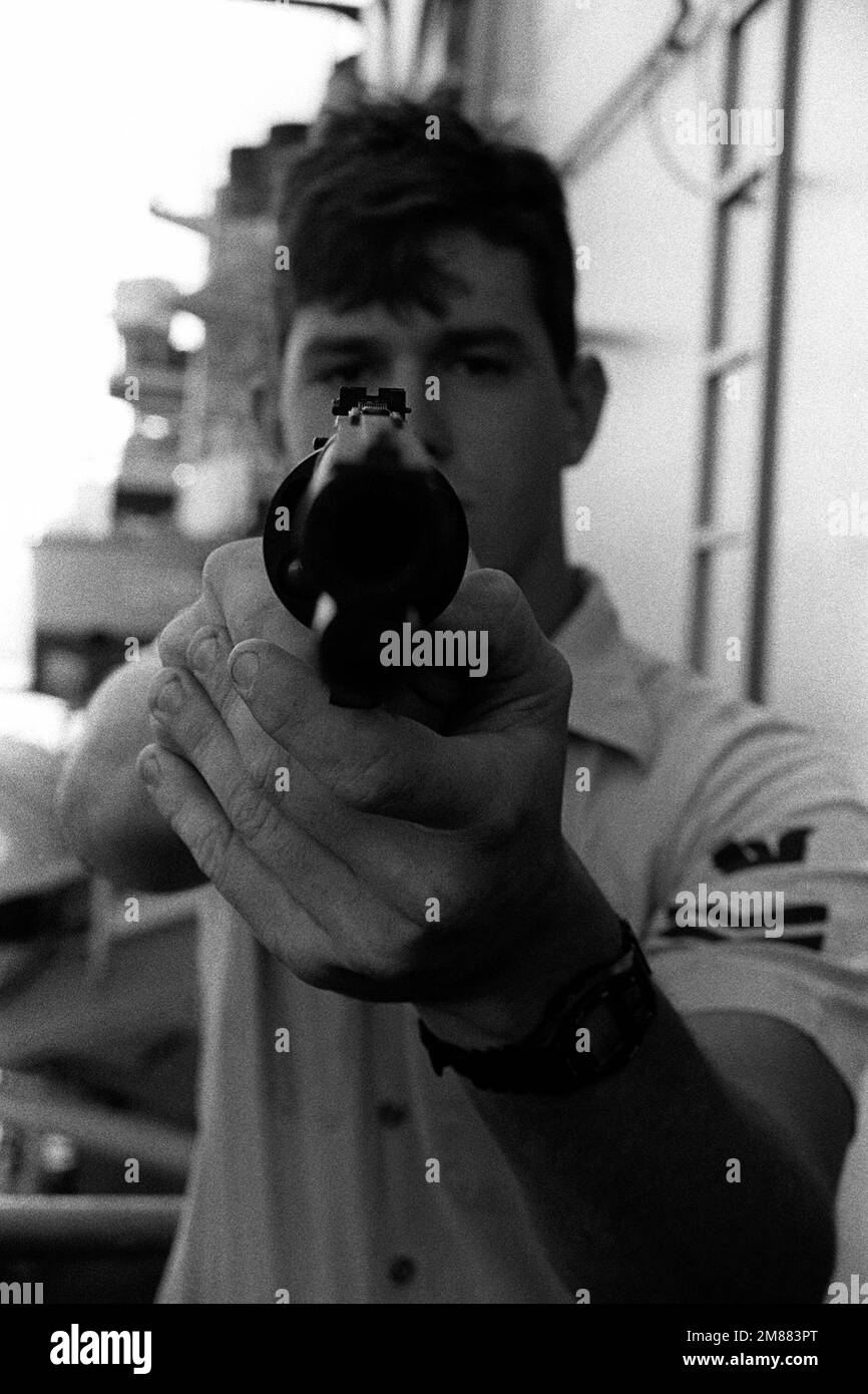 Fire Controlman 2nd Class Arthur Forbis demonstrates the use of a paint ...