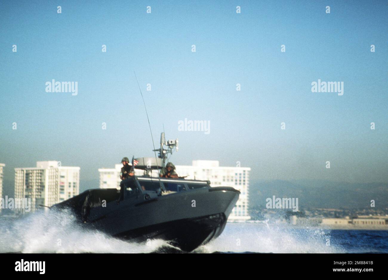 Sea-Air-Land (SEAL) team members ride aboard a Seafox special warfare ...