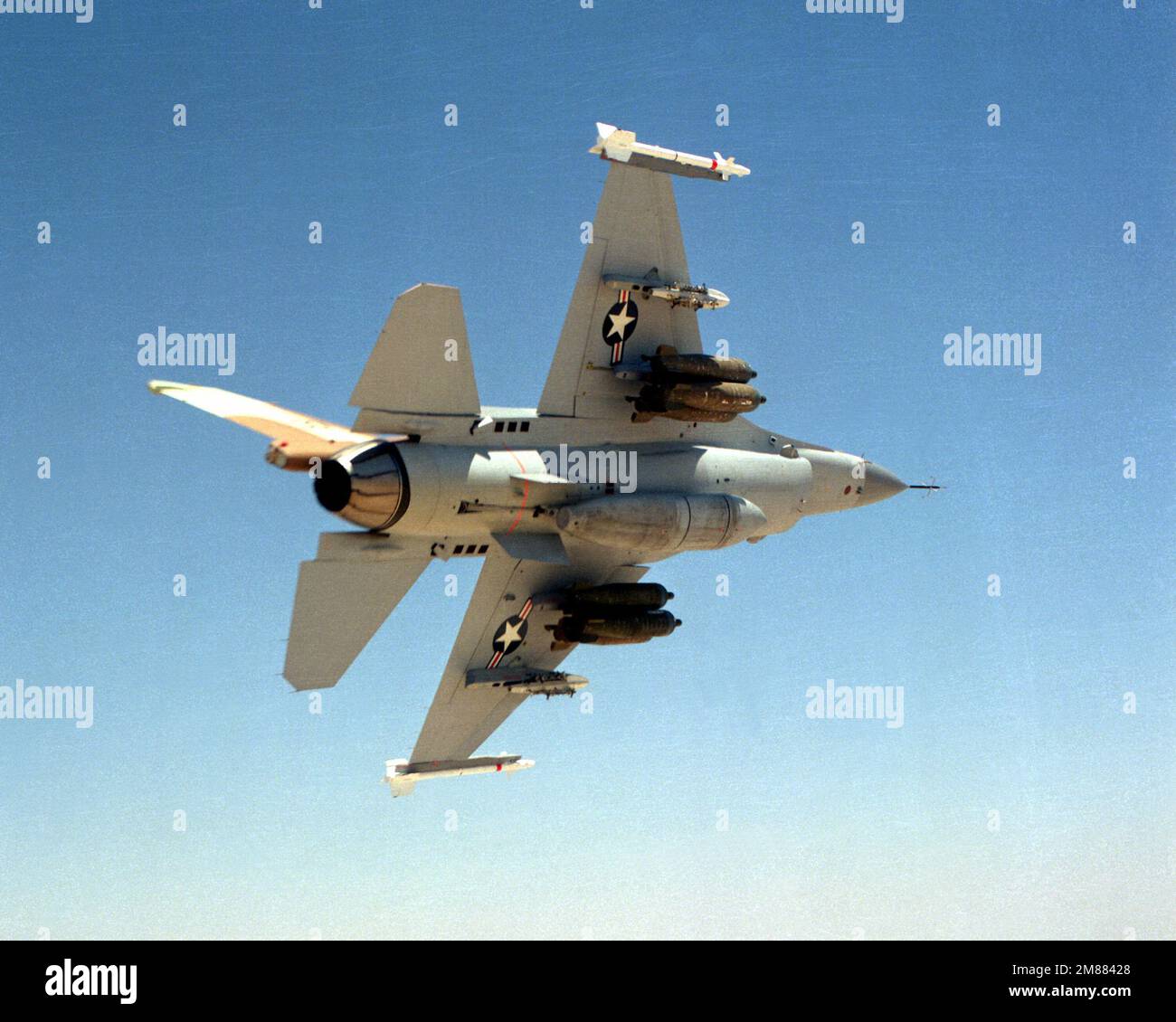 An air-to-air right underside view of an F-16 Fighting Falcon aircraft ...