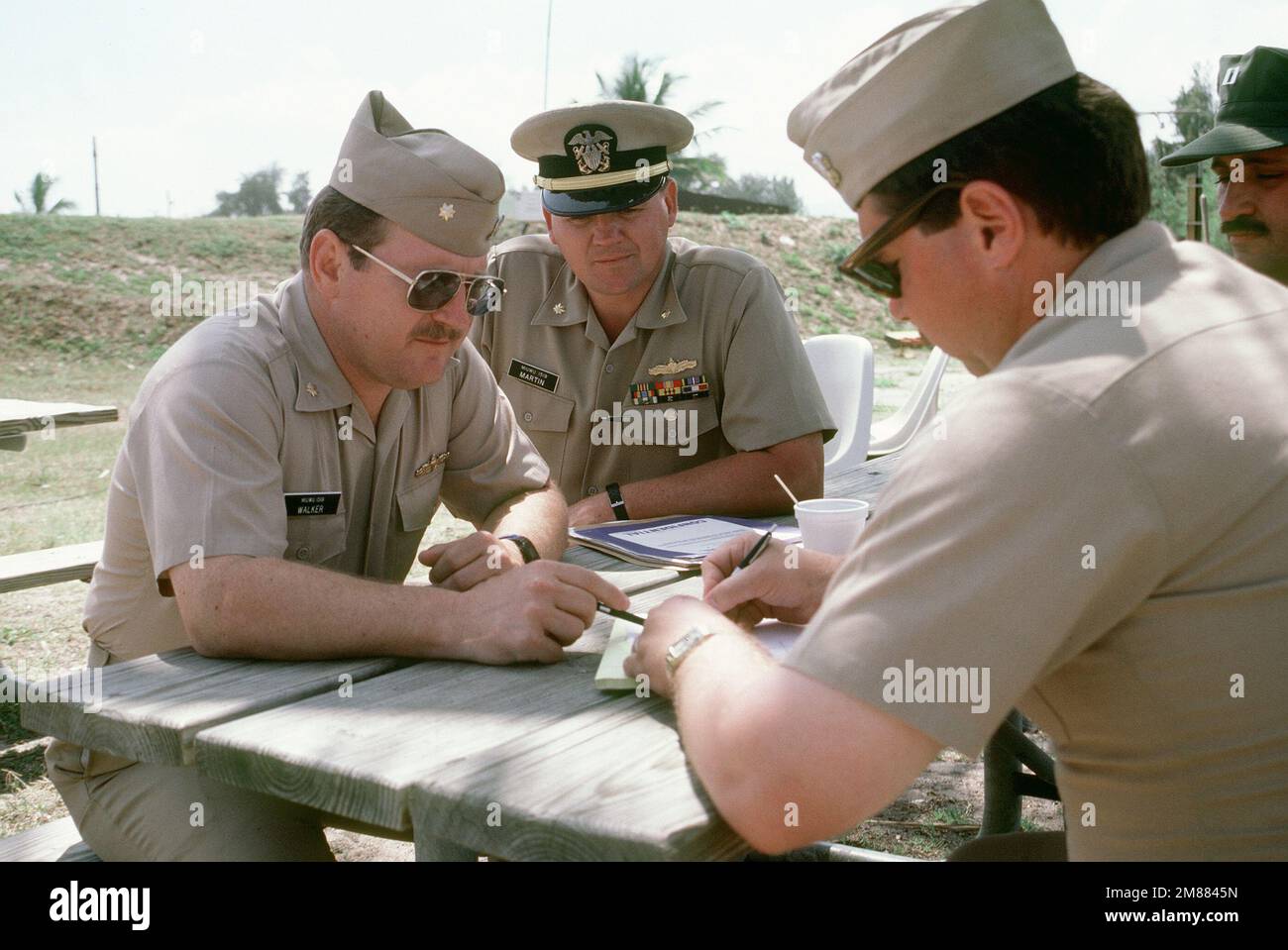 U.S. Navy officers of Mobile Inshore Undersea Warfare Unit 1519 discuss ...
