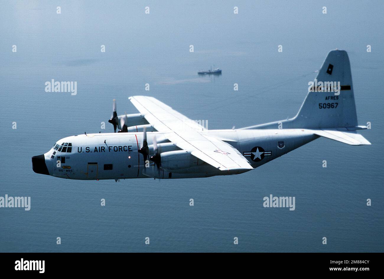 An air-to-air left side view of a WC-130H Hercules aircraft in-flight ...