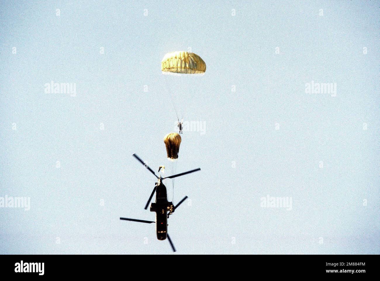Trainees parachute from a CH-46 Sea Knight helicopter during Basic ...