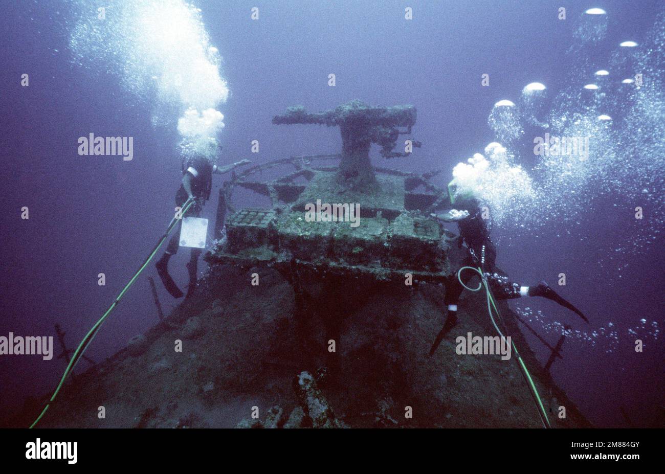 Navy divers from Moible Diving Salvage Unit One measure the remains of ...