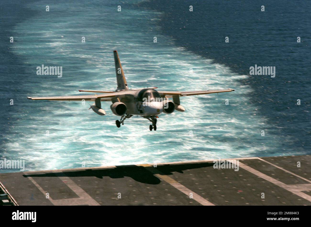 An S-3 Viking aircraft comes in for a landing on the flight deck of the ...
