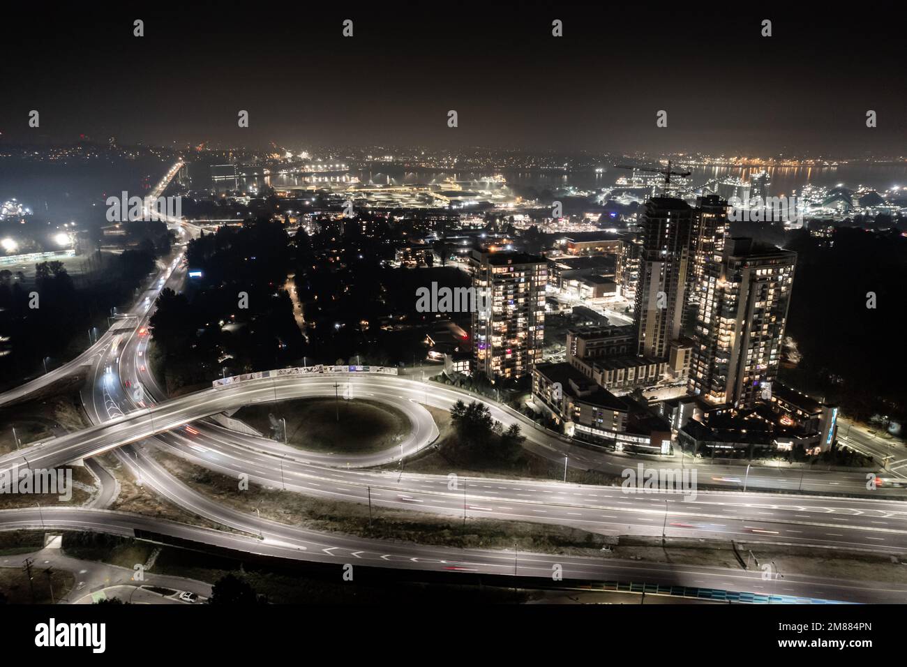 Night highway, cars on the highway, aerial footage, apartment buildings ...