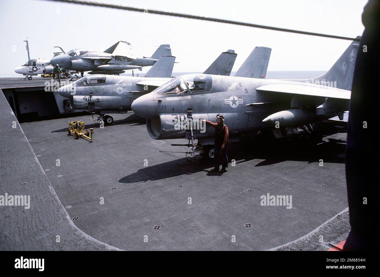 Flight deck crewmen prepare an Attack Squadron 72 (VA-72) A-7E Corsair ...