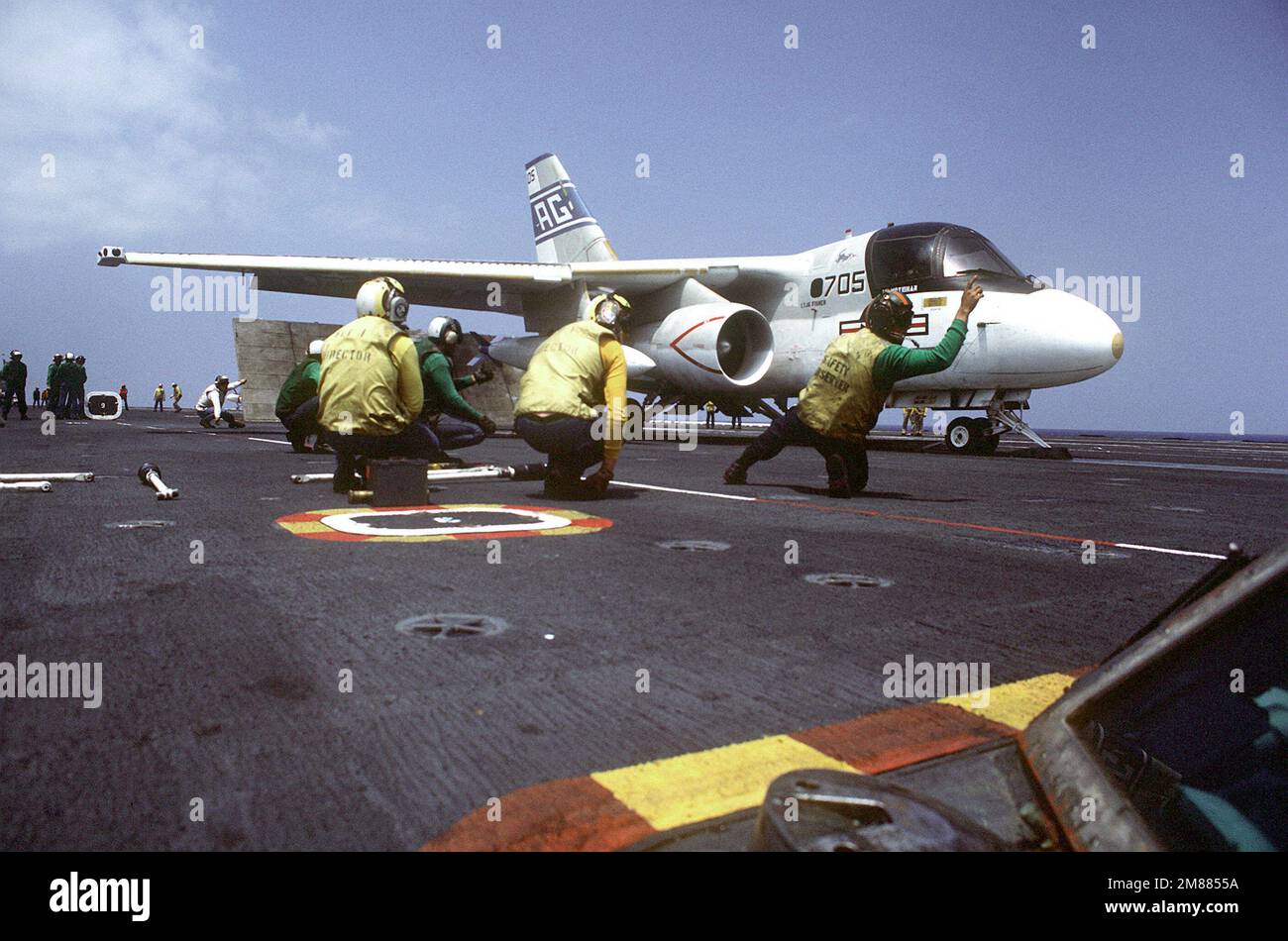 A safety observer signals instructions to the pilot of an S-3A Viking ...