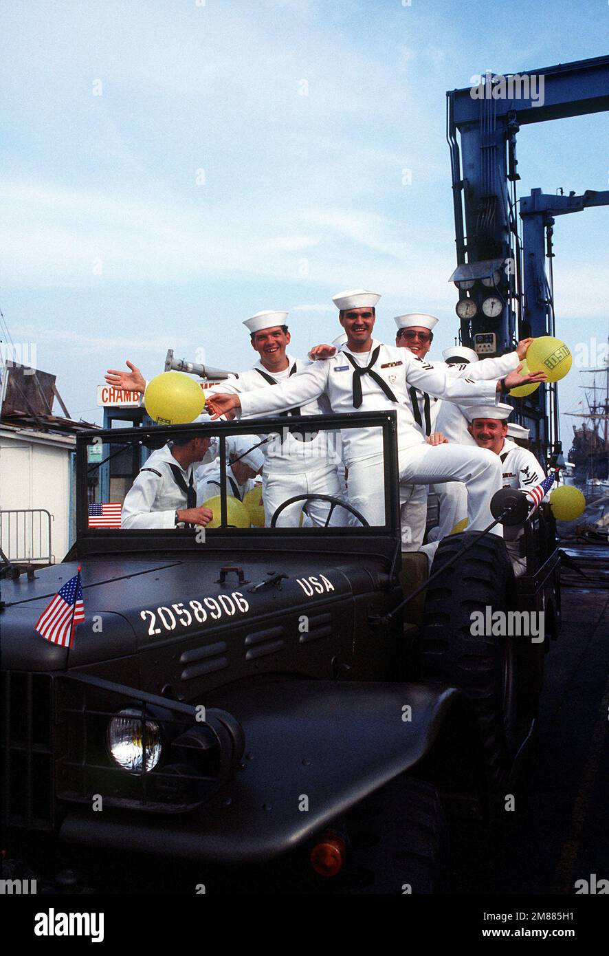 U.S. Navy personnel pose for the camera while standing in an authentic ...