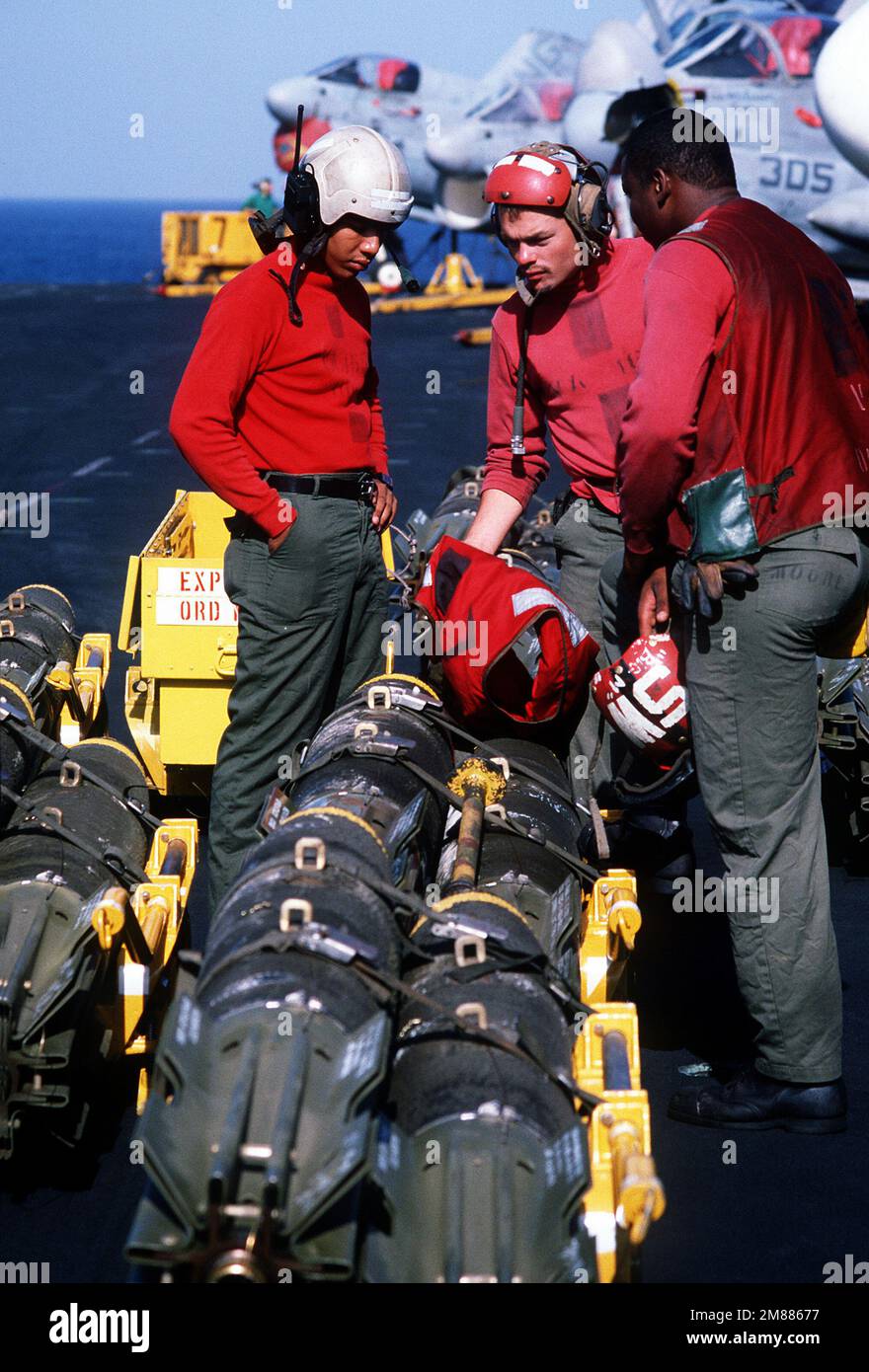 Ordnancemen of Attack Squadron 165 (VA-165) prepare to load Mark 82 500 ...