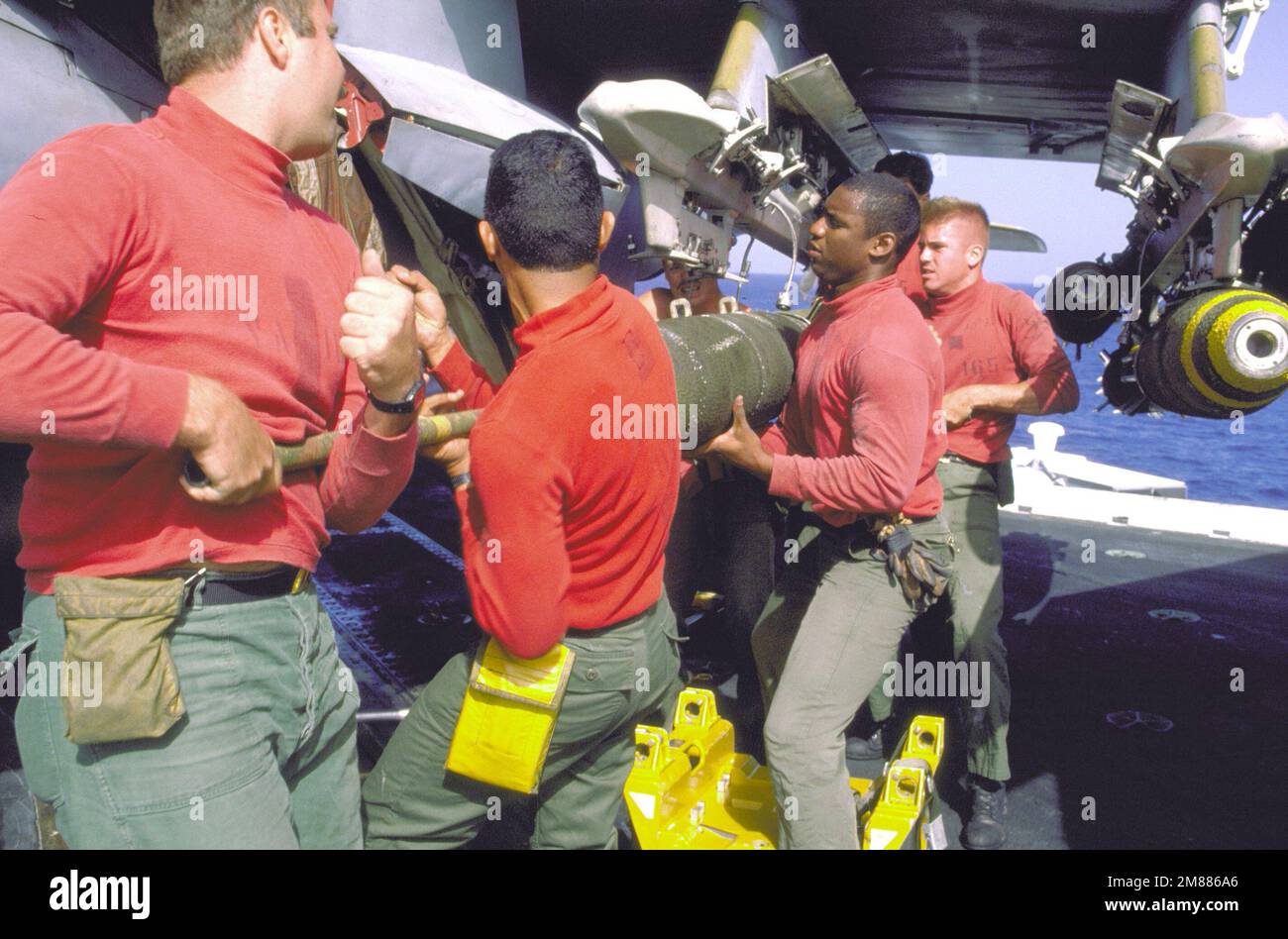 Ordnancemen of Attack Squadron 165 (VA-165) mount a Mark 82 500-pound ...