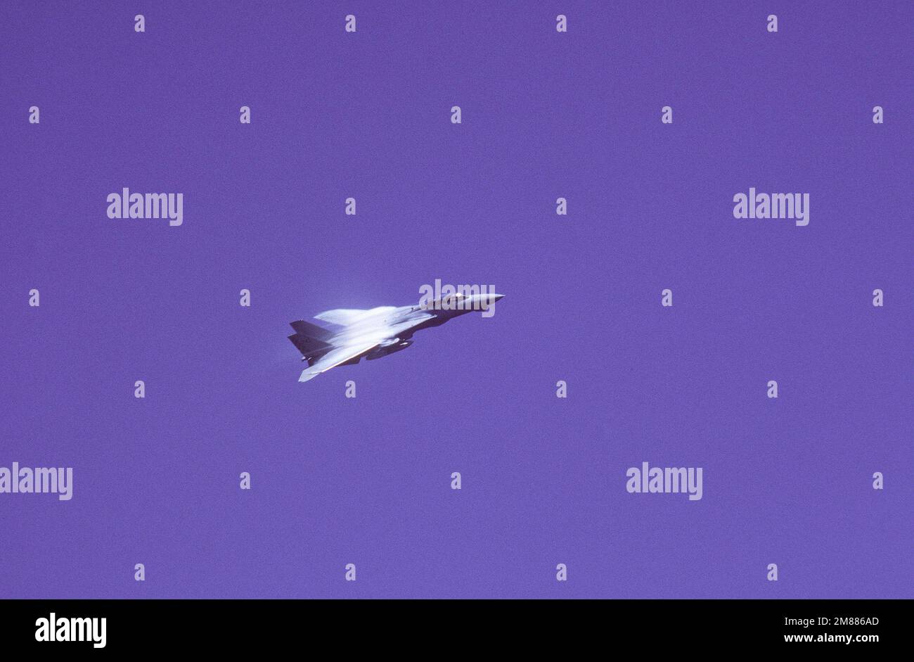 An air-to-air right side view of an F-14A Tomcat aircraft. The white ...