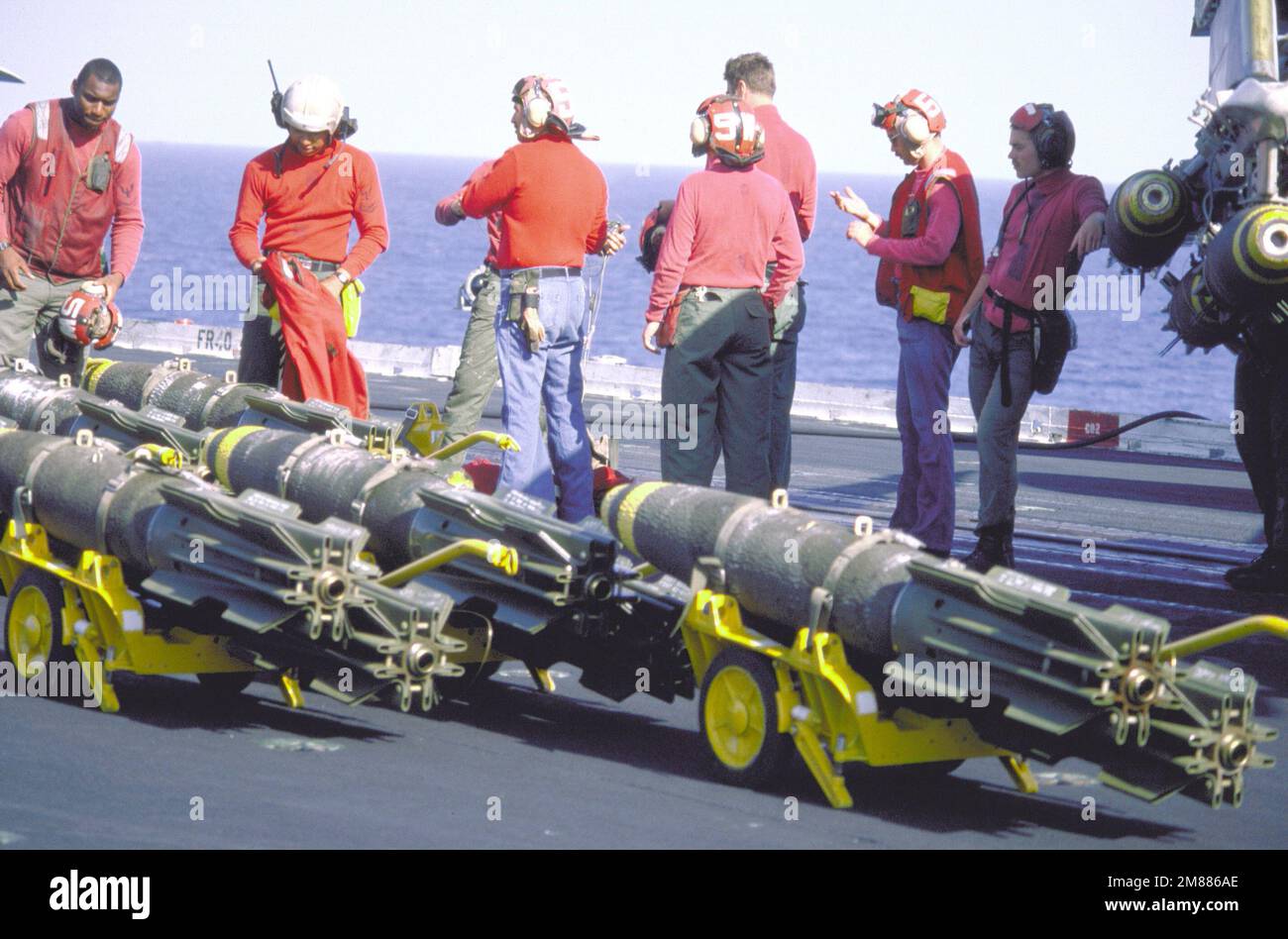 Ordnancemen of Attack Squadron 165 (VA-165) stand by to load Mark 82 ...