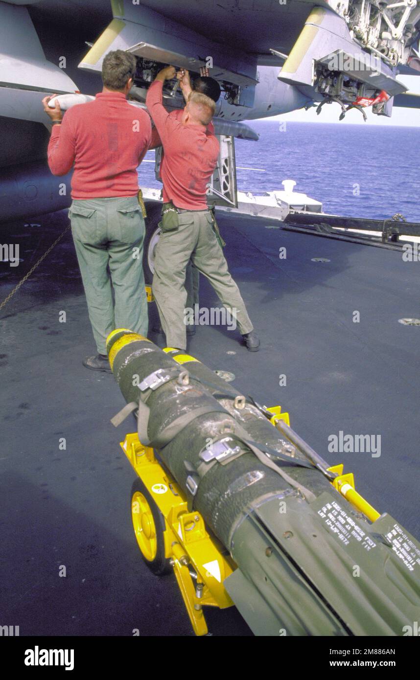 Ordnancemen of Attack Squadron 165 (VA-165) prepare to load Mark 82 500 ...