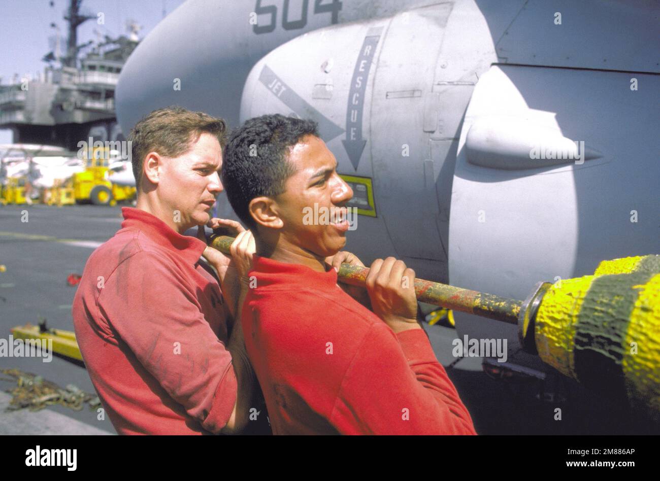 Ordnancemen of Attack Squadron 165 (VA-165) mount a Mark 82 500 pound ...