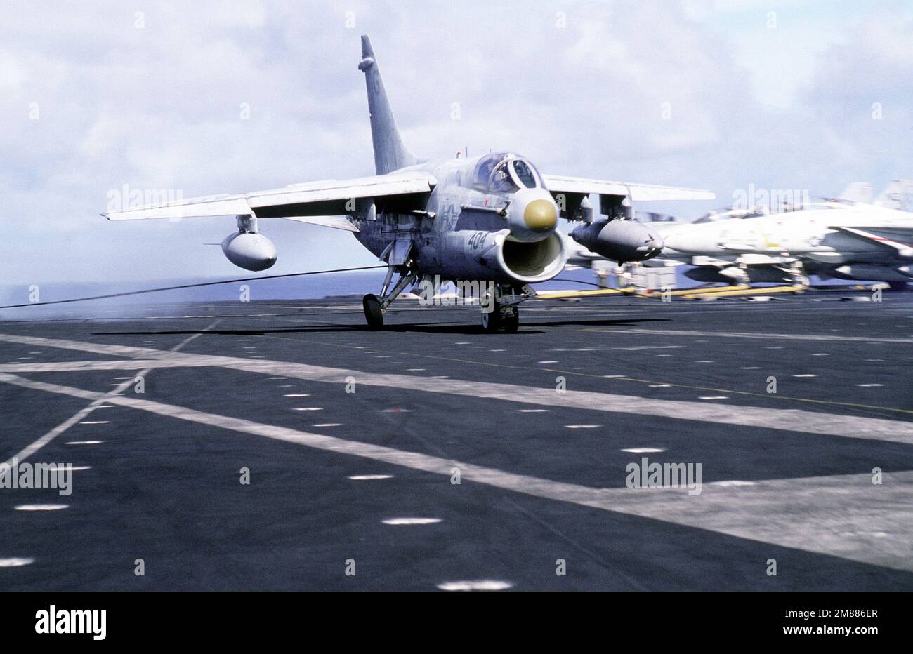 An A-7E Corsair II aircraft lands aboard the aircraft carrier USS KITTY ...