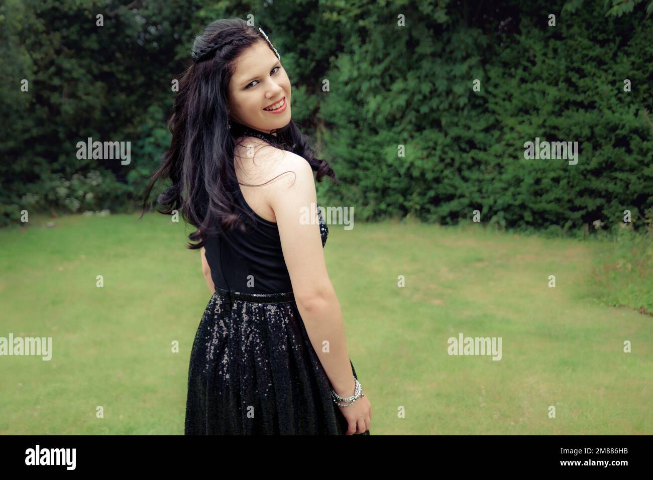 Back of a teenage girl in black sequin racerback prom dress Stock Photo ...