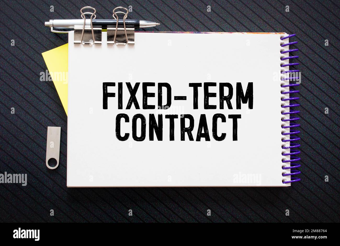 Top view clock and miniature people with text Fixed-Term Contract on a ...