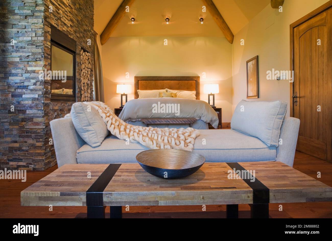 Wooden medeival style coffee table and grey daybed with throw and king ...