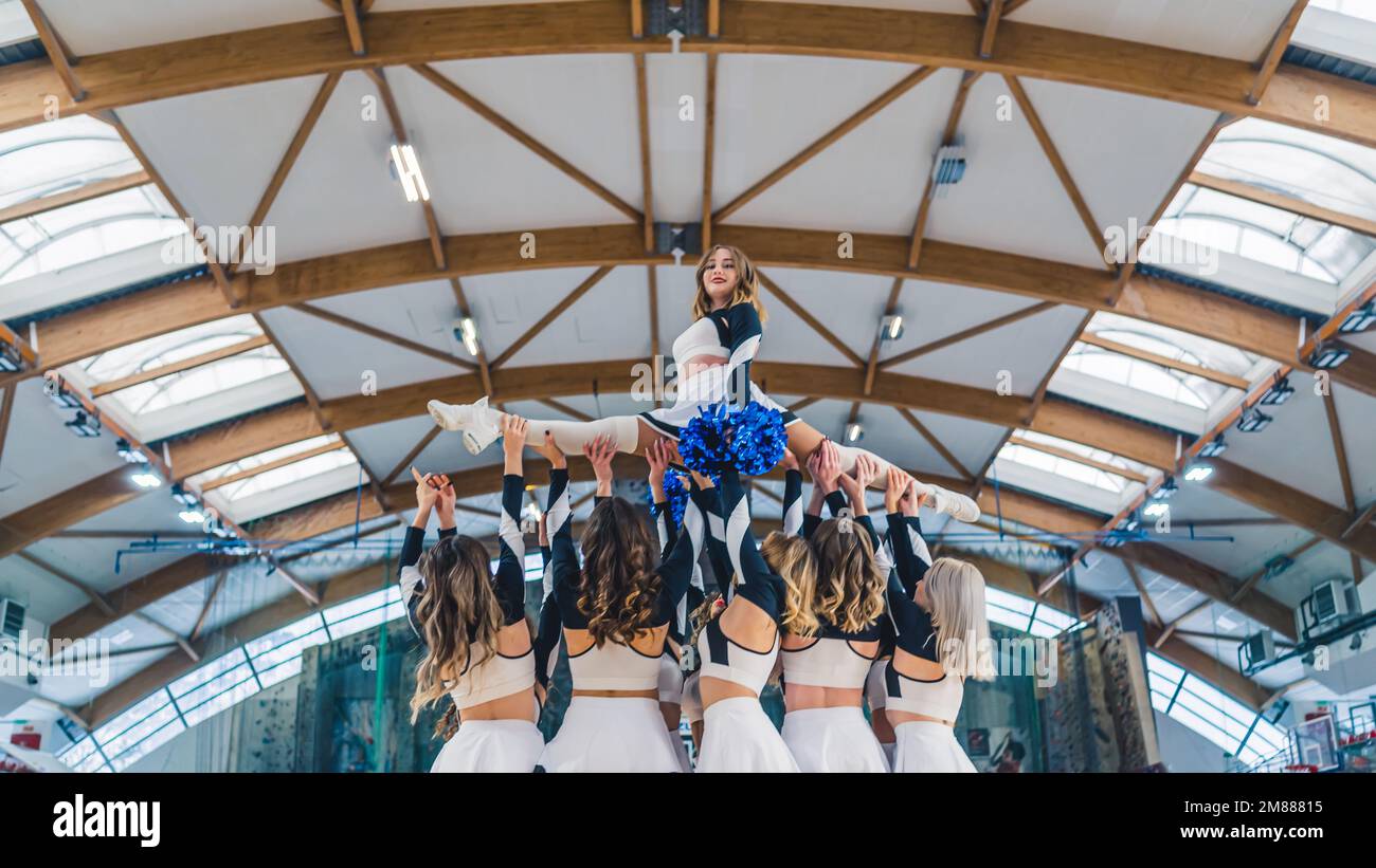 High-angle view of a group of cheerleaders captured in a dynamic and ...