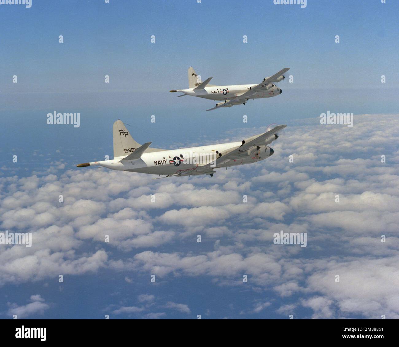 An air-to-air right rear view of two Patrol Squadron 31 (VP-31) P-3C ...