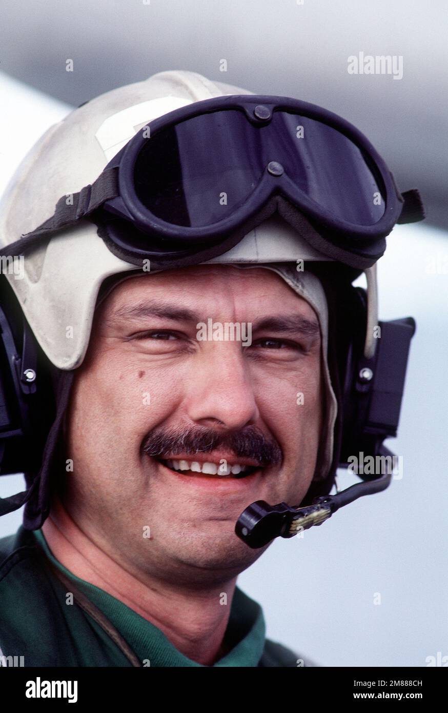A flight deck crewman poses for a photo during flight operations aboard ...