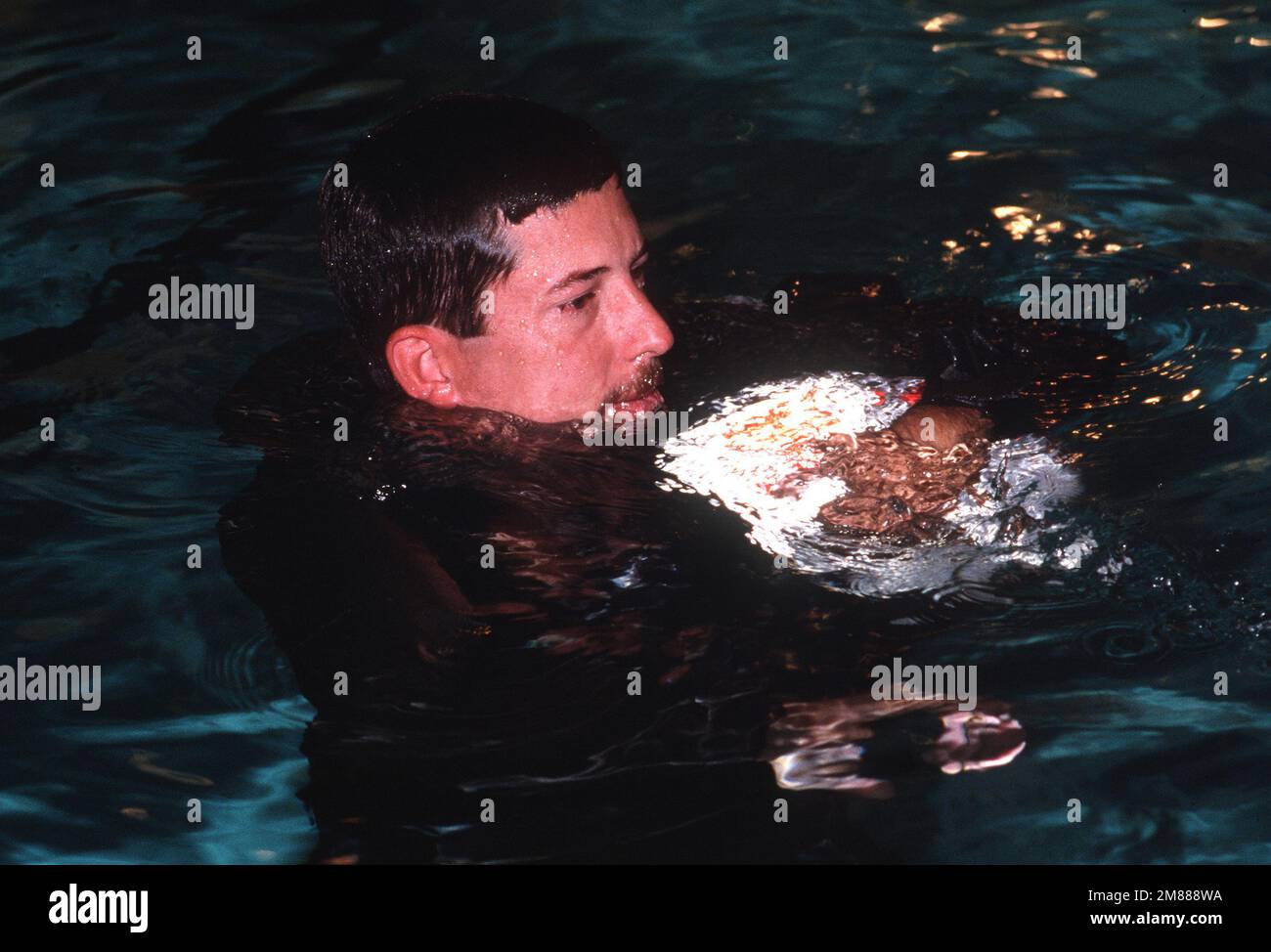 A student demonstrates the drown-proofing survival float at the station ...