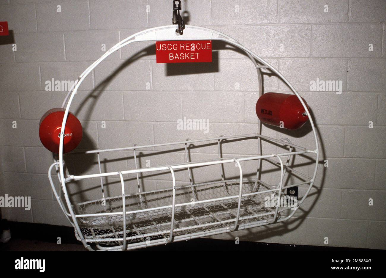 A Coast Guard rescue basket is displayed at the station's Aviation ...