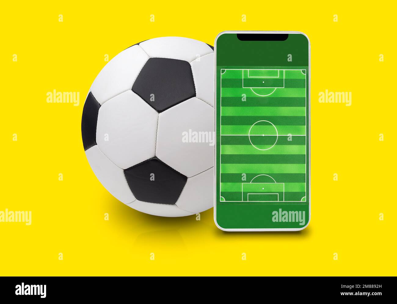Mobile phone football online with yellow background Stock Photo - Alamy