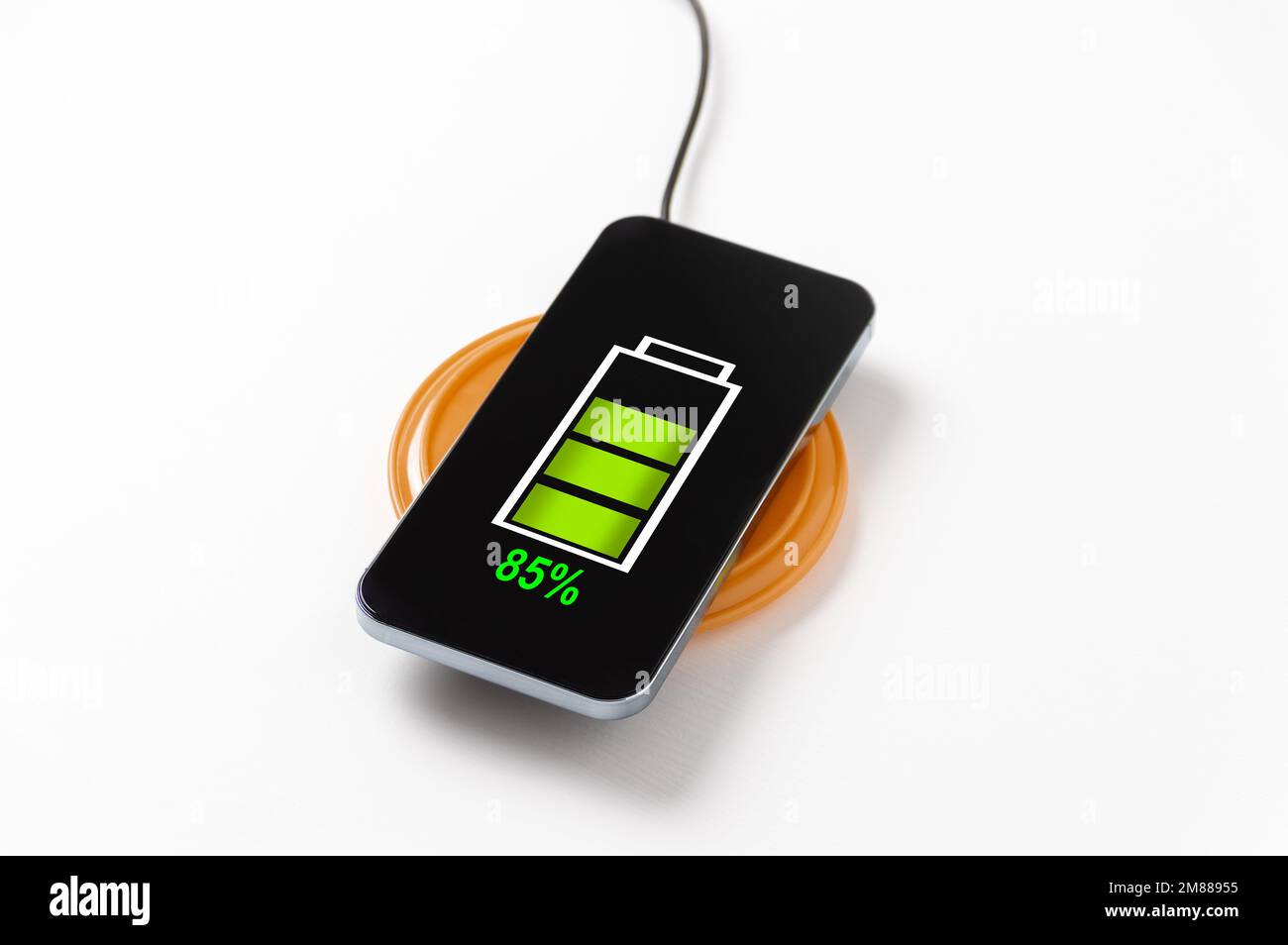 Close up of wireless charging of modern black glossy metal touchscreen ...