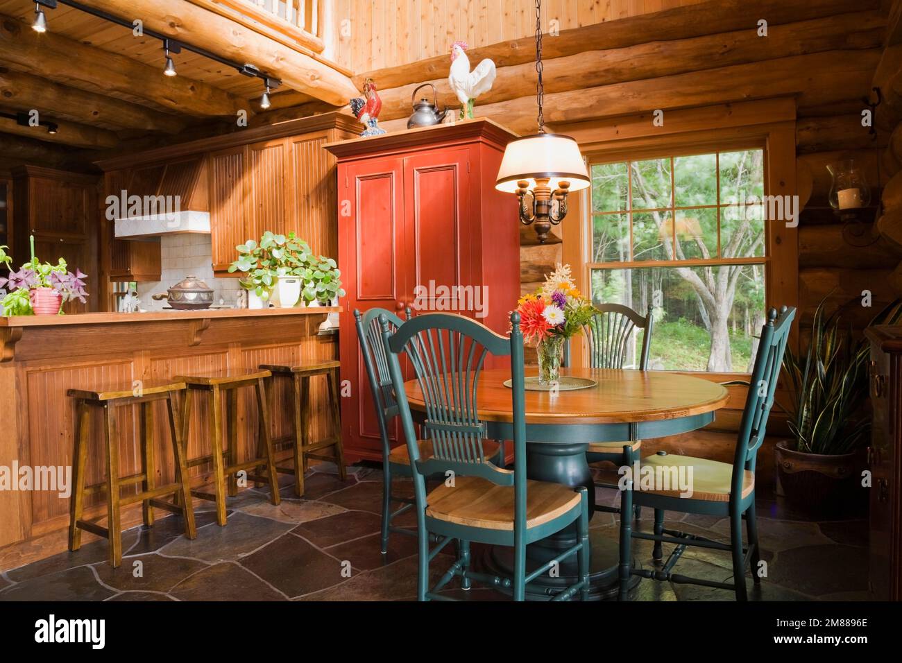 Round wooden antique dining table with high back chairs and kitchen bar ...