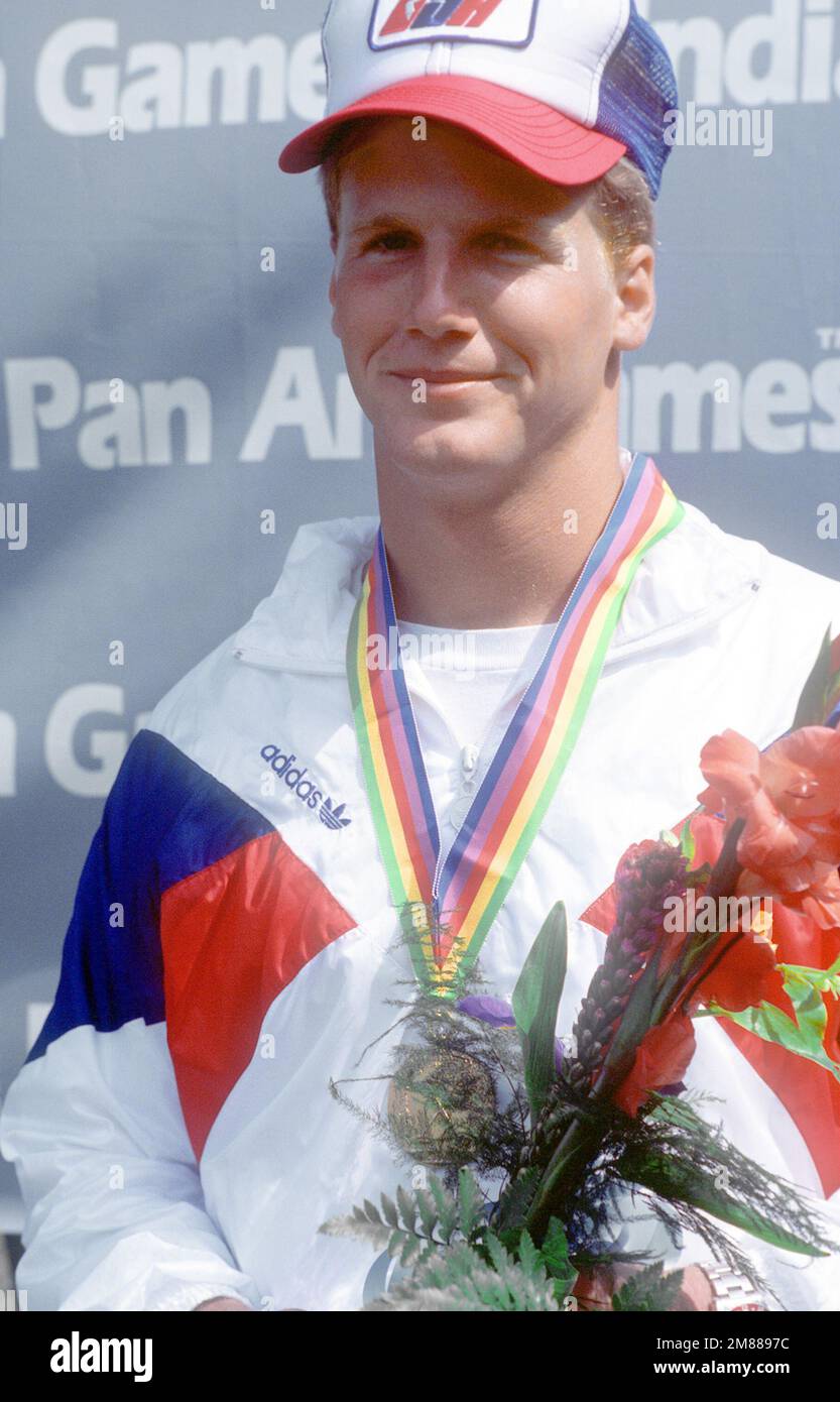 SPEC. 4 George A. Haas stands proudly with his gold medal and a bouquet ...