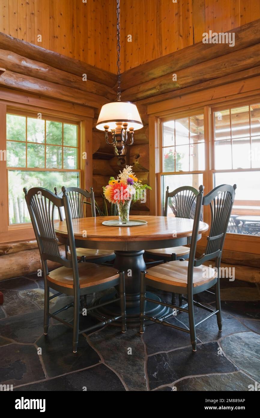 Round wooden antique dining table with high back chairs in dining room ...