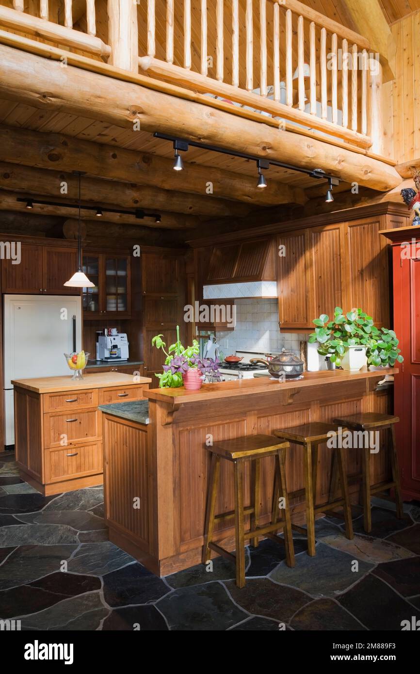 Kitchen bar with barstools in kitchen with slate tile floor inside ...