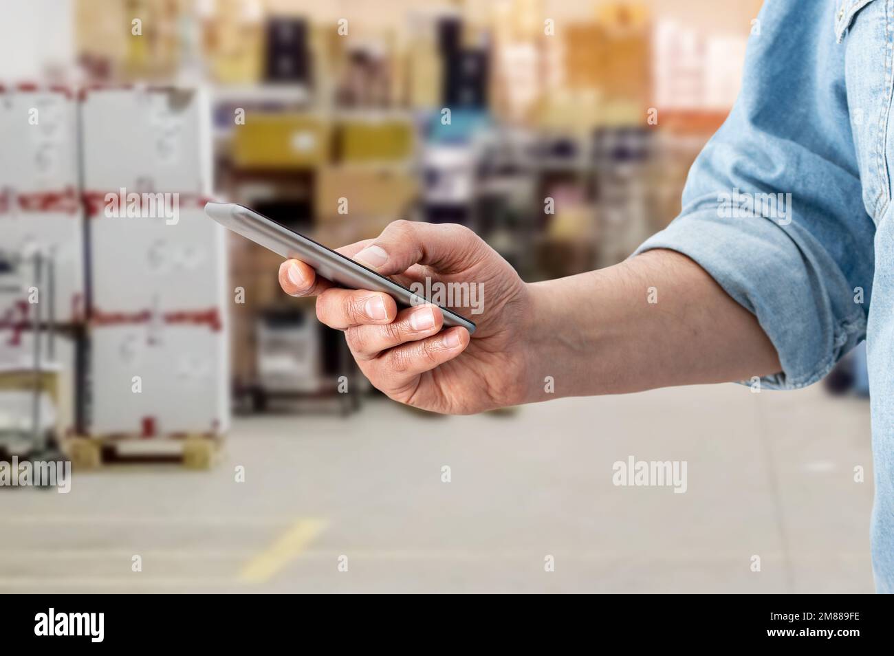 Warehouse factory contact holding mobile cell phone. Man hand holding ...
