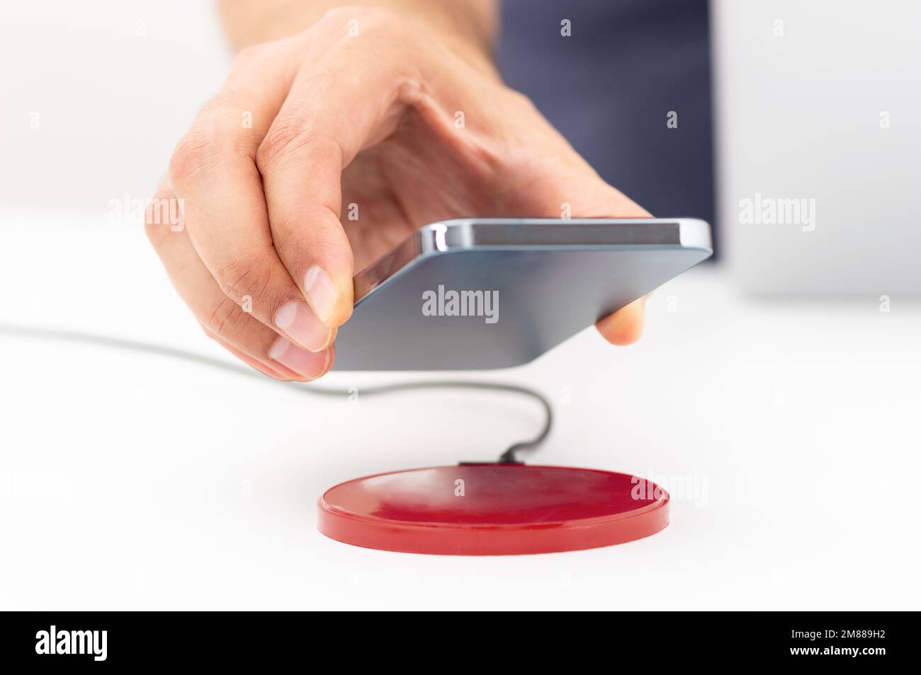 Man charging smartphone using wireless pad at home Stock Photo - Alamy