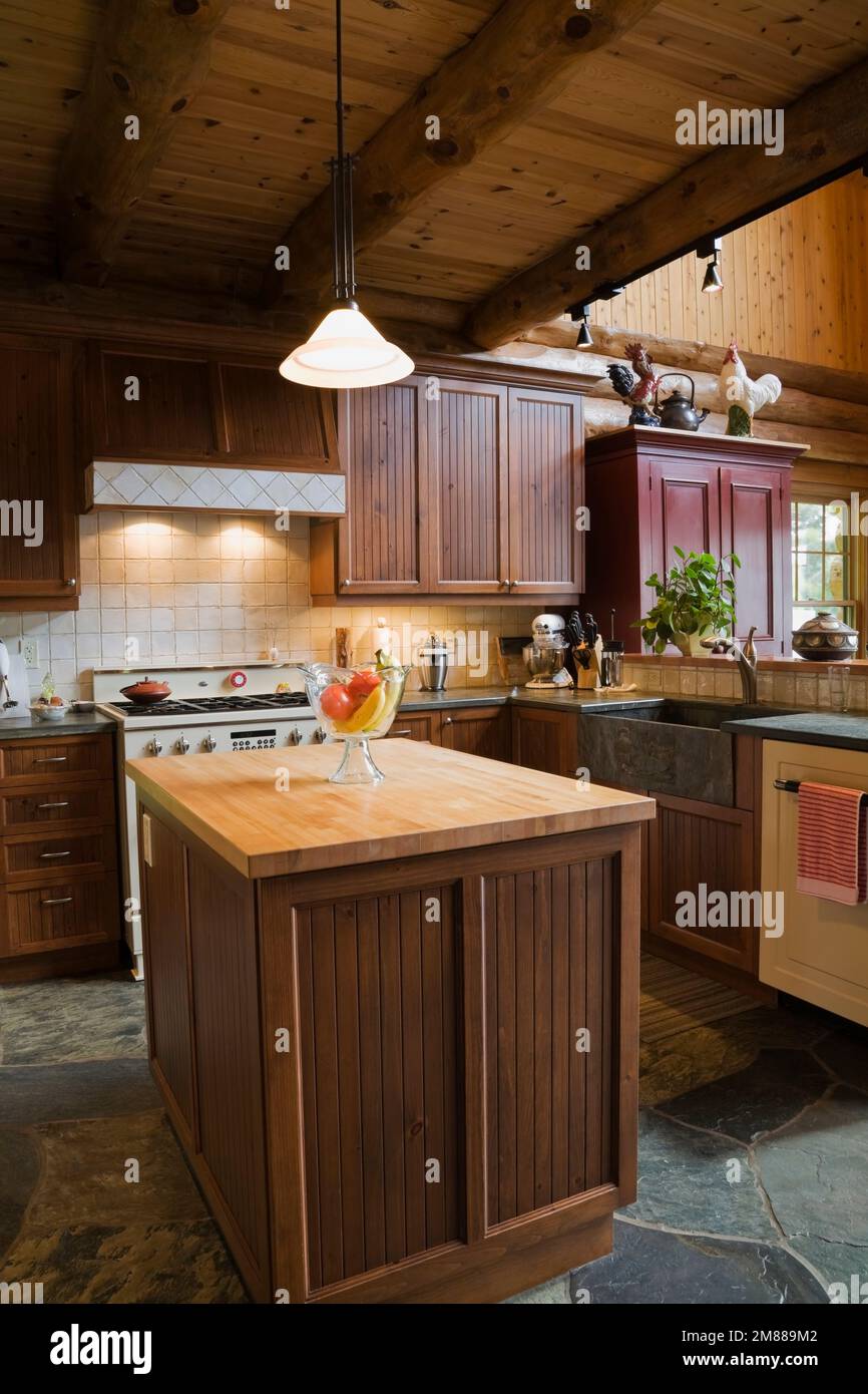 Country style kitchen with island and slate tile floor inside ...