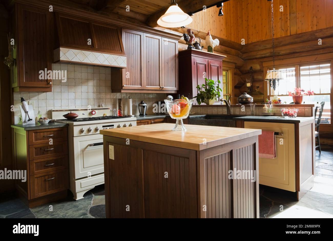 Country style kitchen with island and slate tile floor inside ...