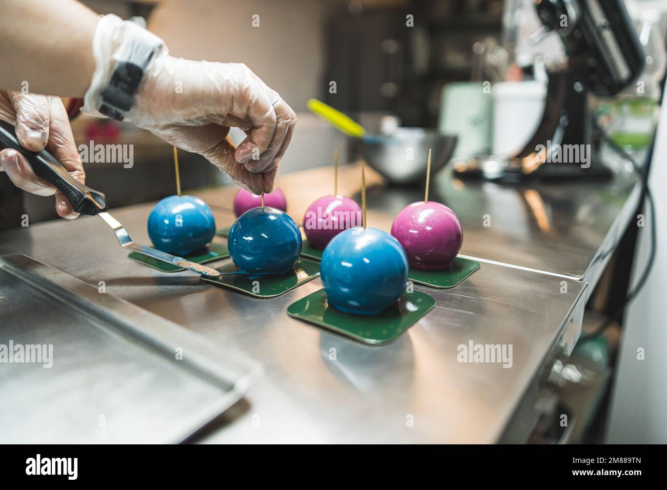 process of making pink and blue chocolate ball cakes in the bakery ...