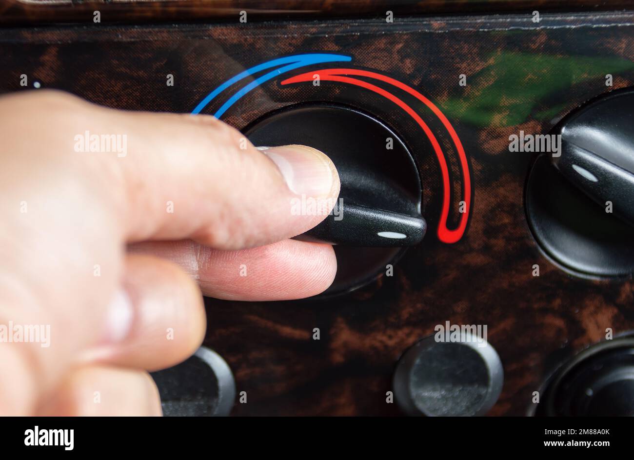Closeup of a human hand rotating car temperature control in heat ...