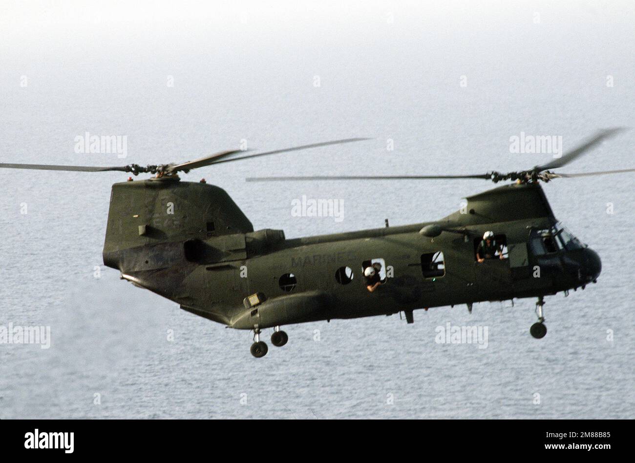 An air-to-air right side view of a U.S. Marine Corps CH-46E Sea Knight helicopter. Country ...