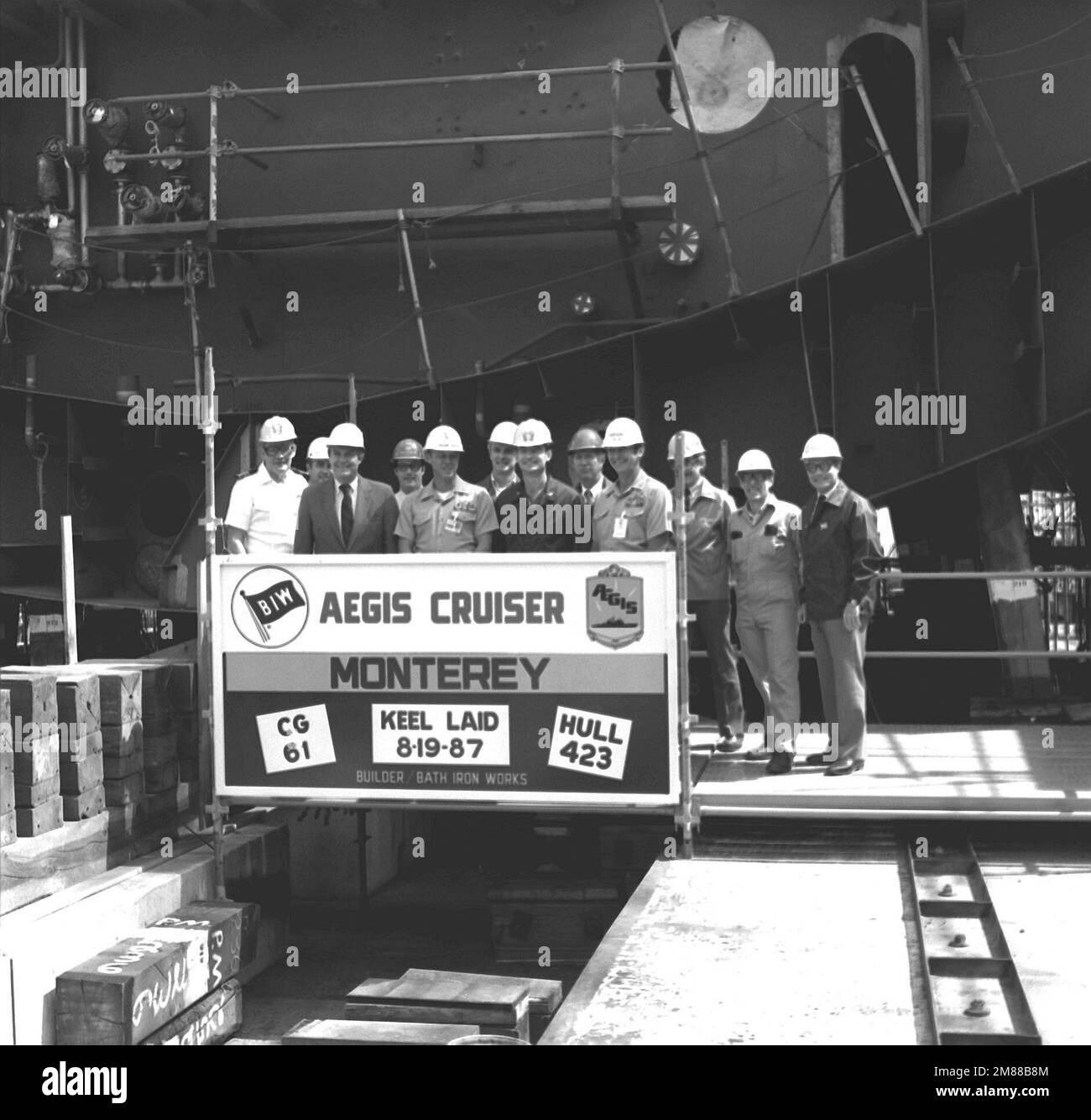Officials of Bath Iron Works and U.S. Navy officers pose for a picture ...