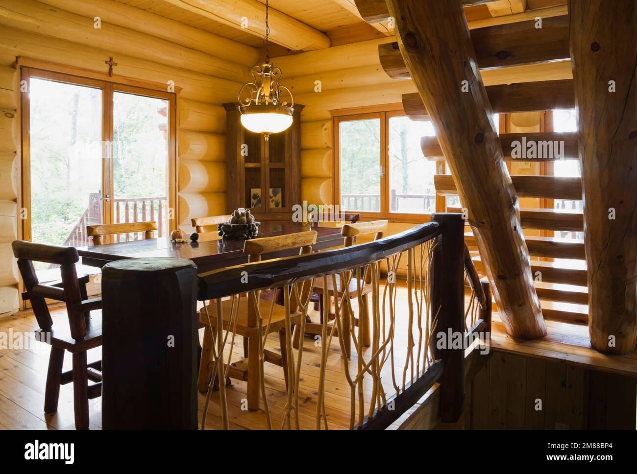 Cedar wood dining table with high back chairs in dining room and ...